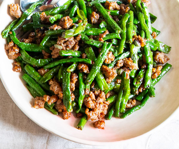 Stir-fried snake beans and pork recipe by Louis Tikaram | Gourmet Traveller